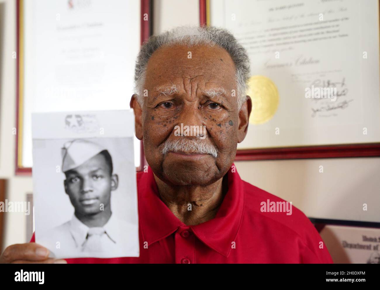 Dr. Harry Quinton, an original Tuskegee Airmen holds his official photo ...
