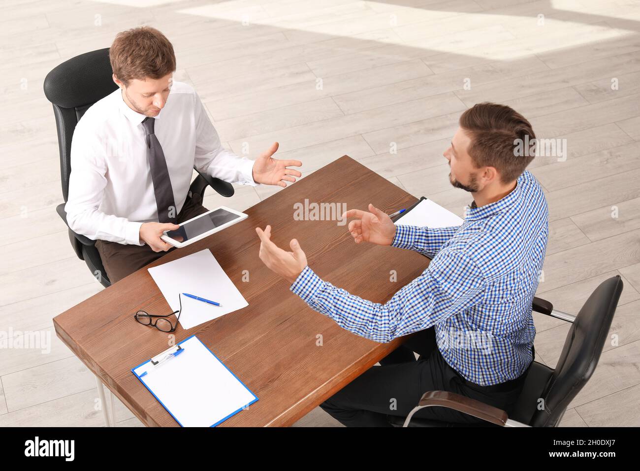 Human resources manager conducting job interview with applicant in office Stock Photo - Alamy