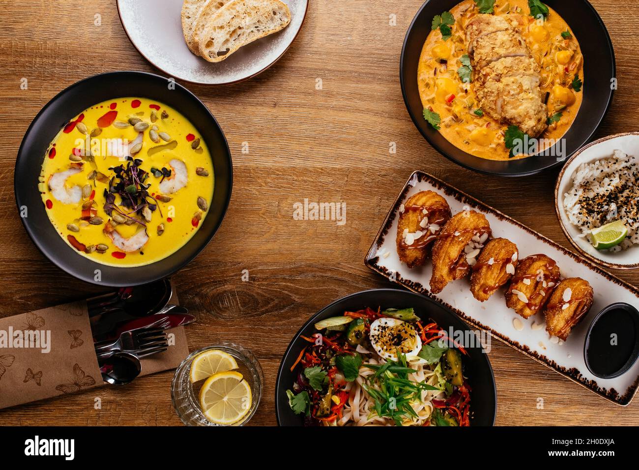 the table is served with a variety of pan-Asian food. Soup. salad. hot ...