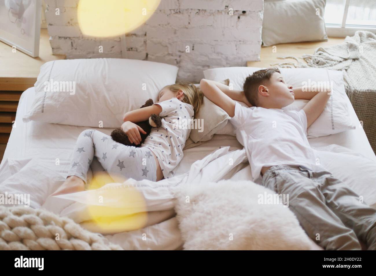 Brother and sister lie in bed top view Stock Photo - Alamy