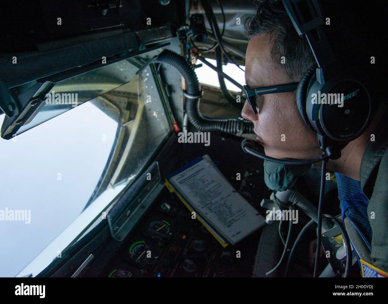 A boom operator from the 6th Air Refueling Wing looks out the boom pod window in a KC-135 ...