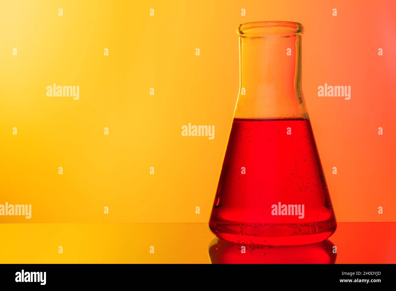 Science concept. Glass test tubes on red background Stock Photo - Alamy