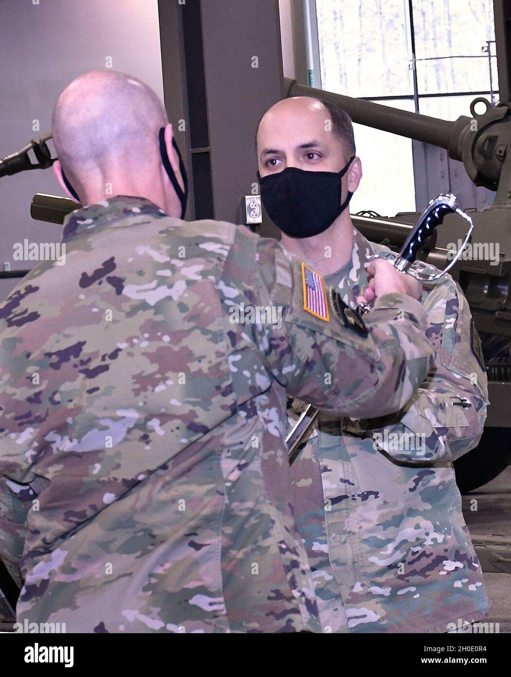 Chief Warrant Officer 5 Danny K. Taylor accepts a saber from Maj. Gen ...