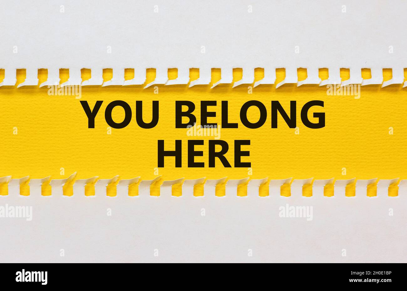 You belong here symbol. Yellow and white paper. Words 'you belong here ...