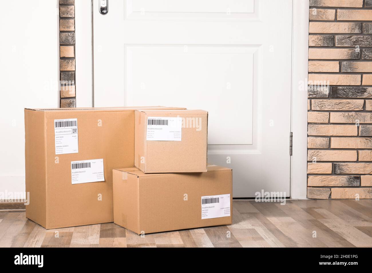 Cardboard parcel boxes on floor near apartment entrance. Mockup for ...