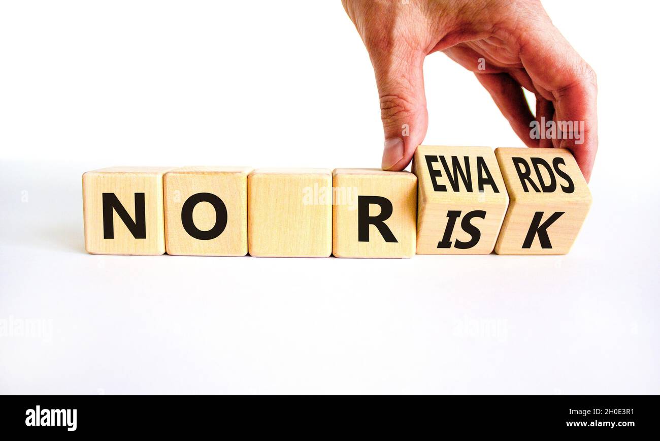 No risk and rewards symbol. Businessman turns wooden cubes and changes ...