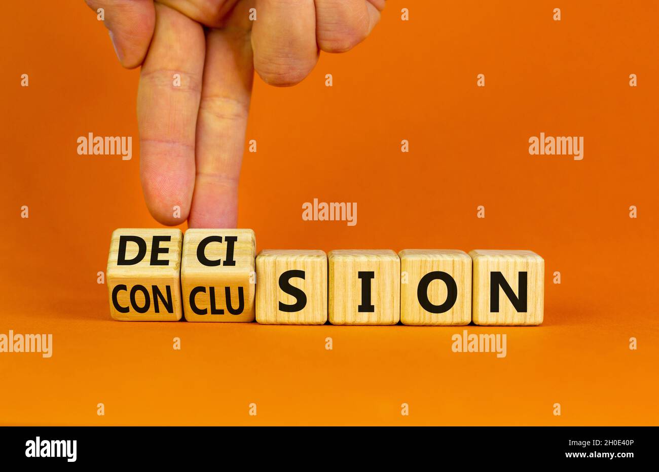 Decision or conclusion symbol. Businessman turns wooden cubes and ...
