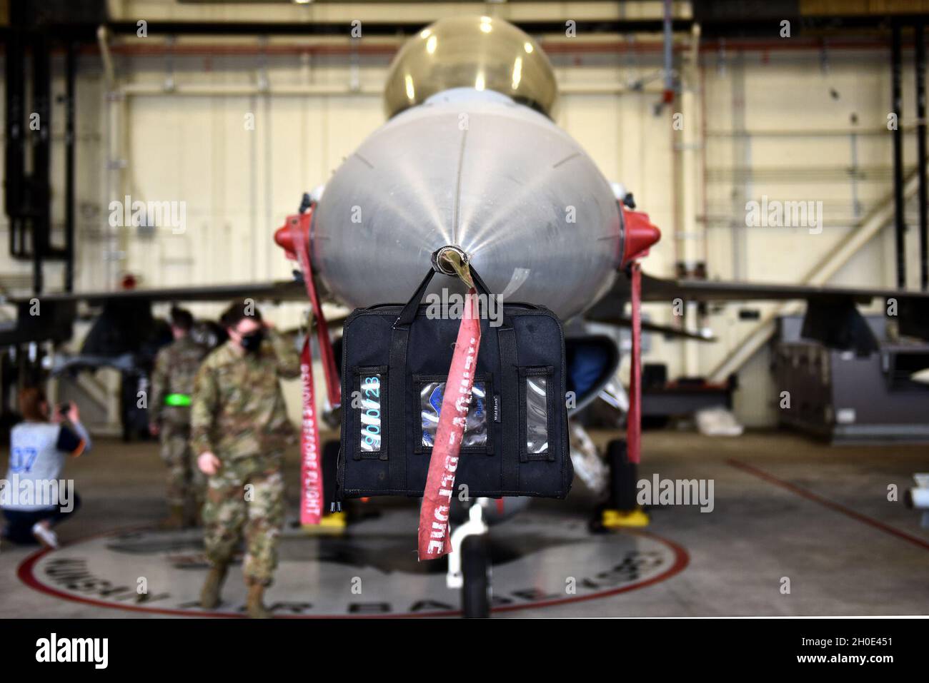 Airmen from the 8th Maintenance Squadron survey an F-16 Fighting Falcon ...