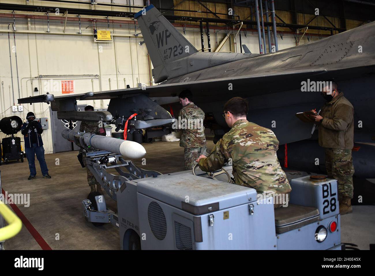 The Armament Flight, 8th Maintenance Squadron, loads an AIM 9 L/M ...