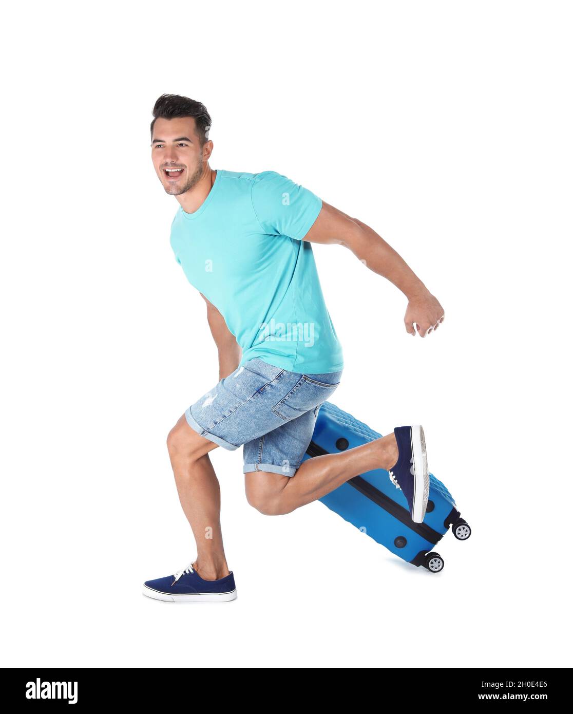 Young man running with suitcase on white background Stock Photo - Alamy