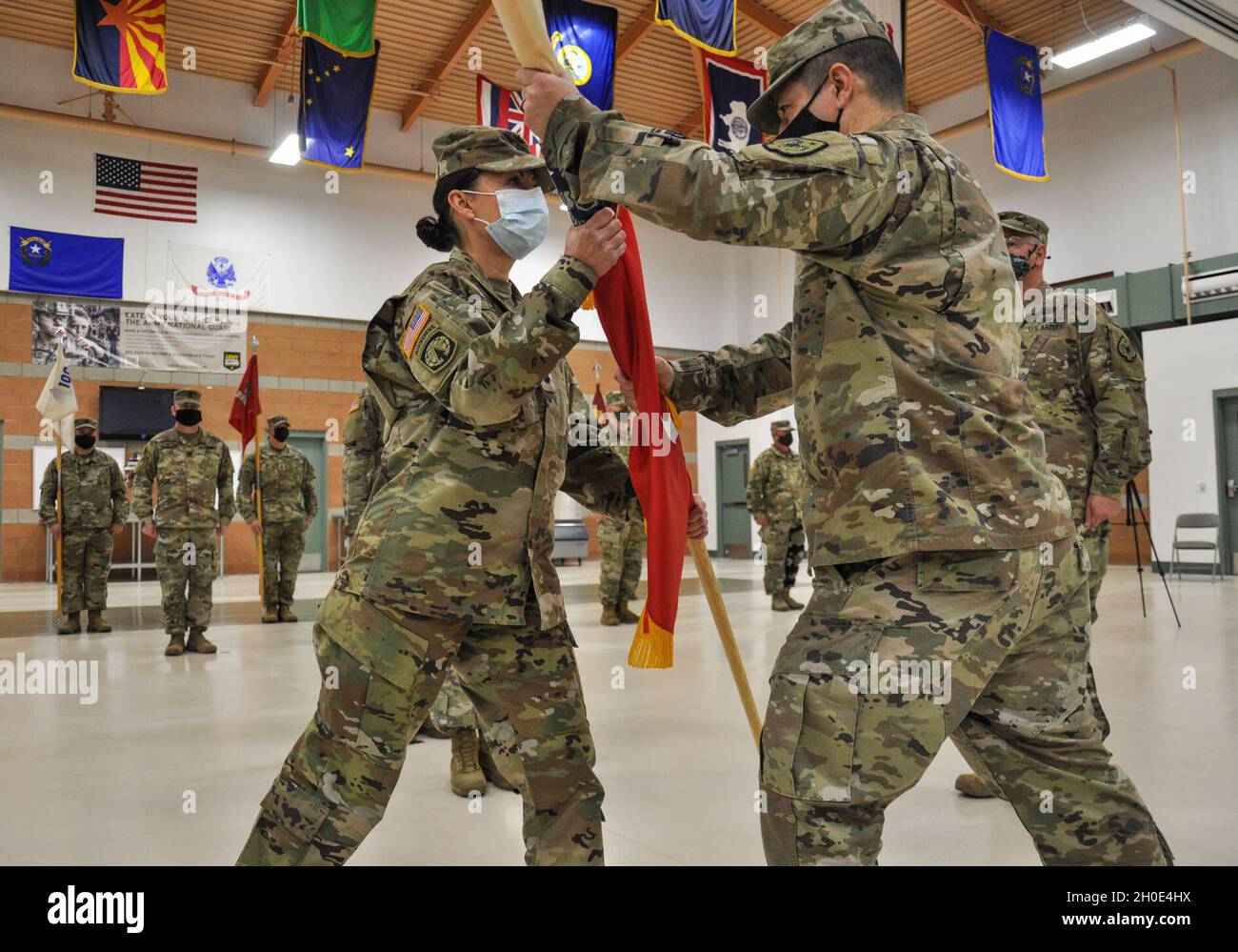 Lt. Col. Stacy Carter receives the unit flag for the passing of colors ...