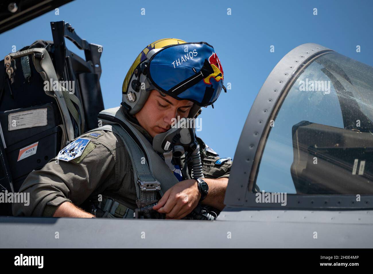 U.S. Air Force pilot Capt. John Stark with the 492nd Fighter Squadron, buckles into an F-15E ...