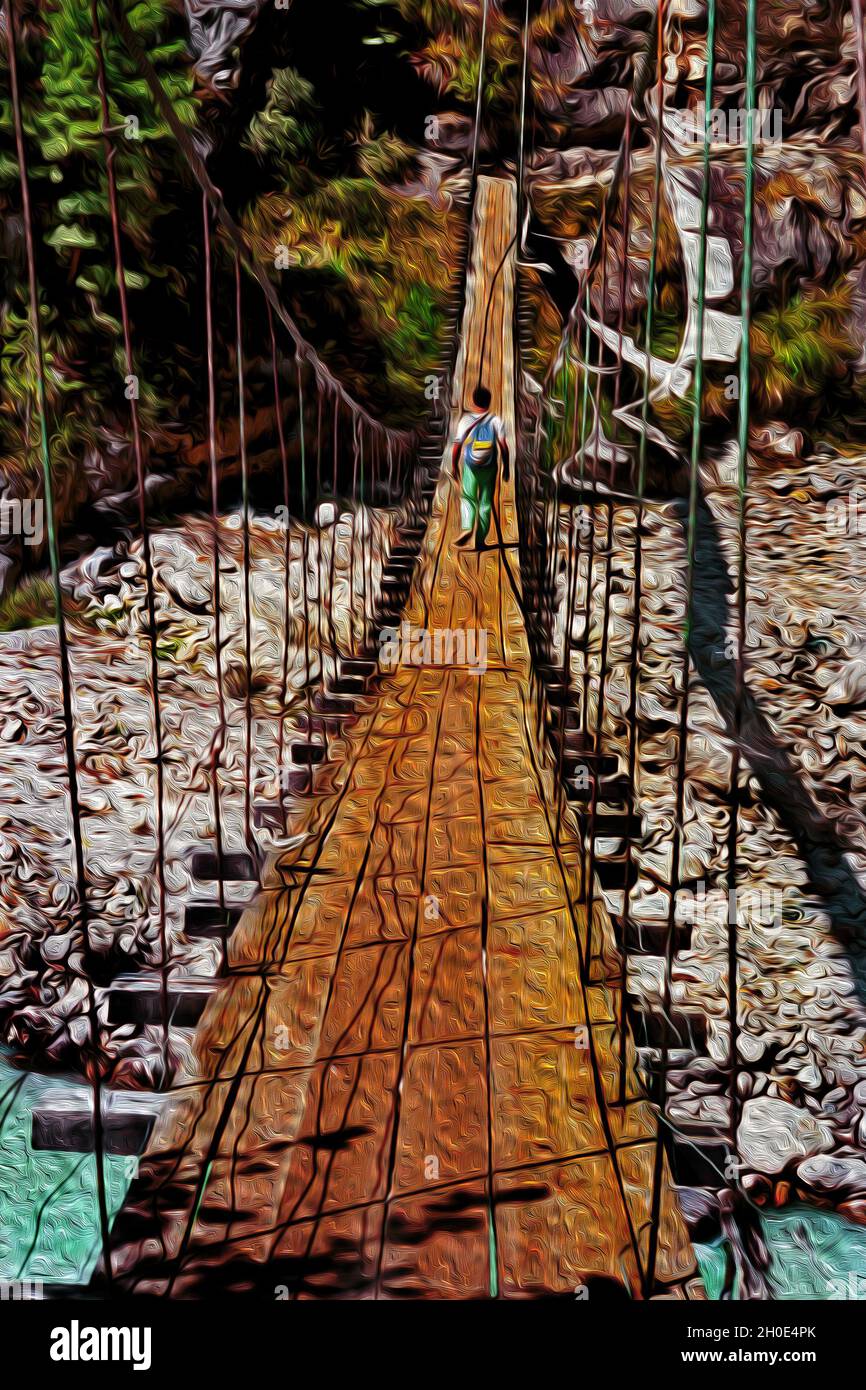 People crossing precarious suspension bridge on trail at the Himalaya ...