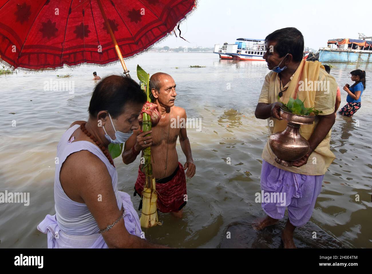 Kolkata, India. 12th Oct, 2021. Hindu devotees give holy dip with ...