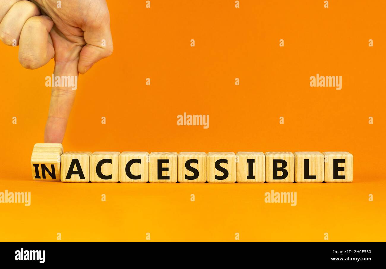 Accessible or inaccessible symbol. Businessman turns a wooden cube ...