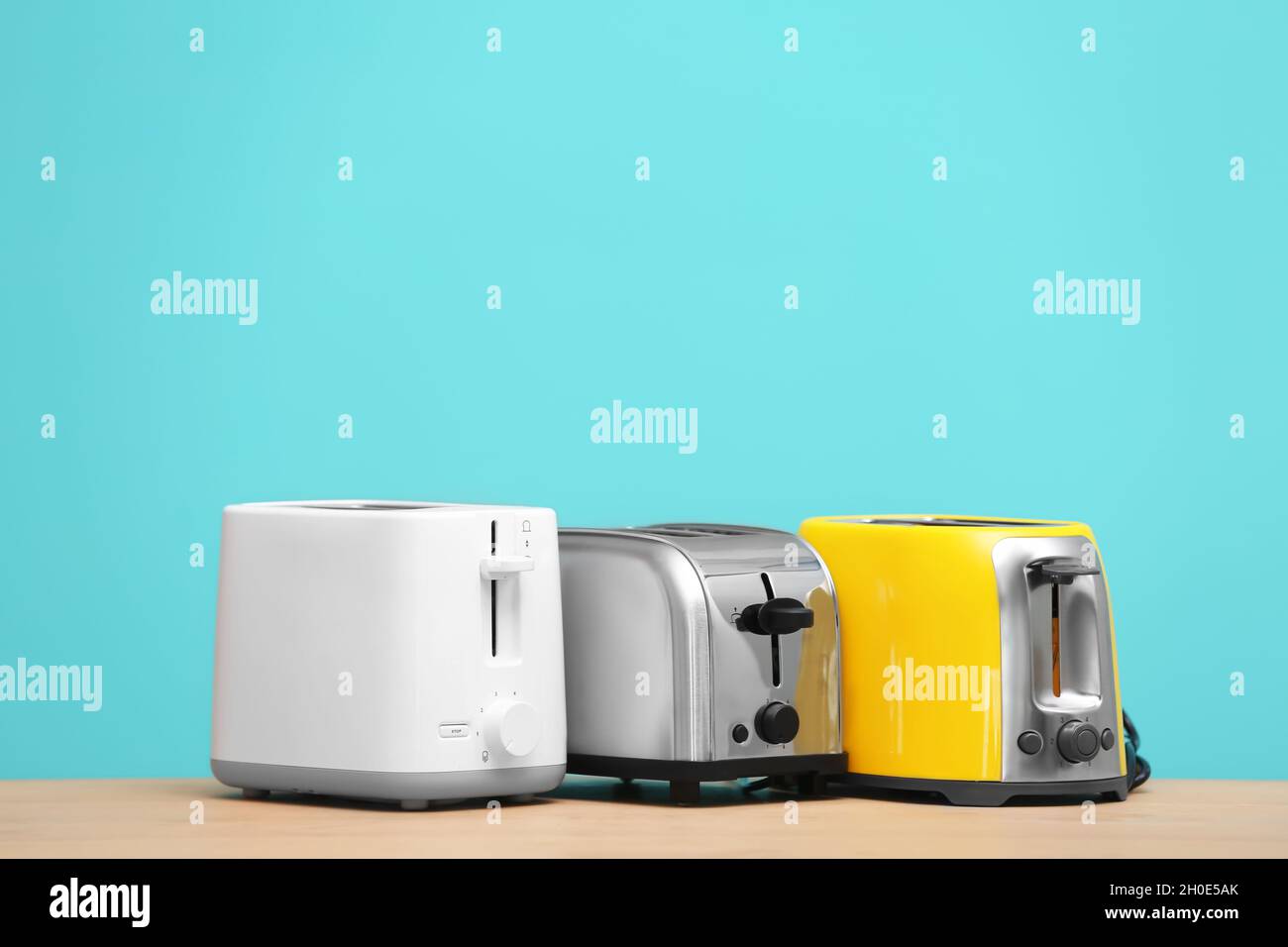 Different toasters on table against color background. Interior element ...