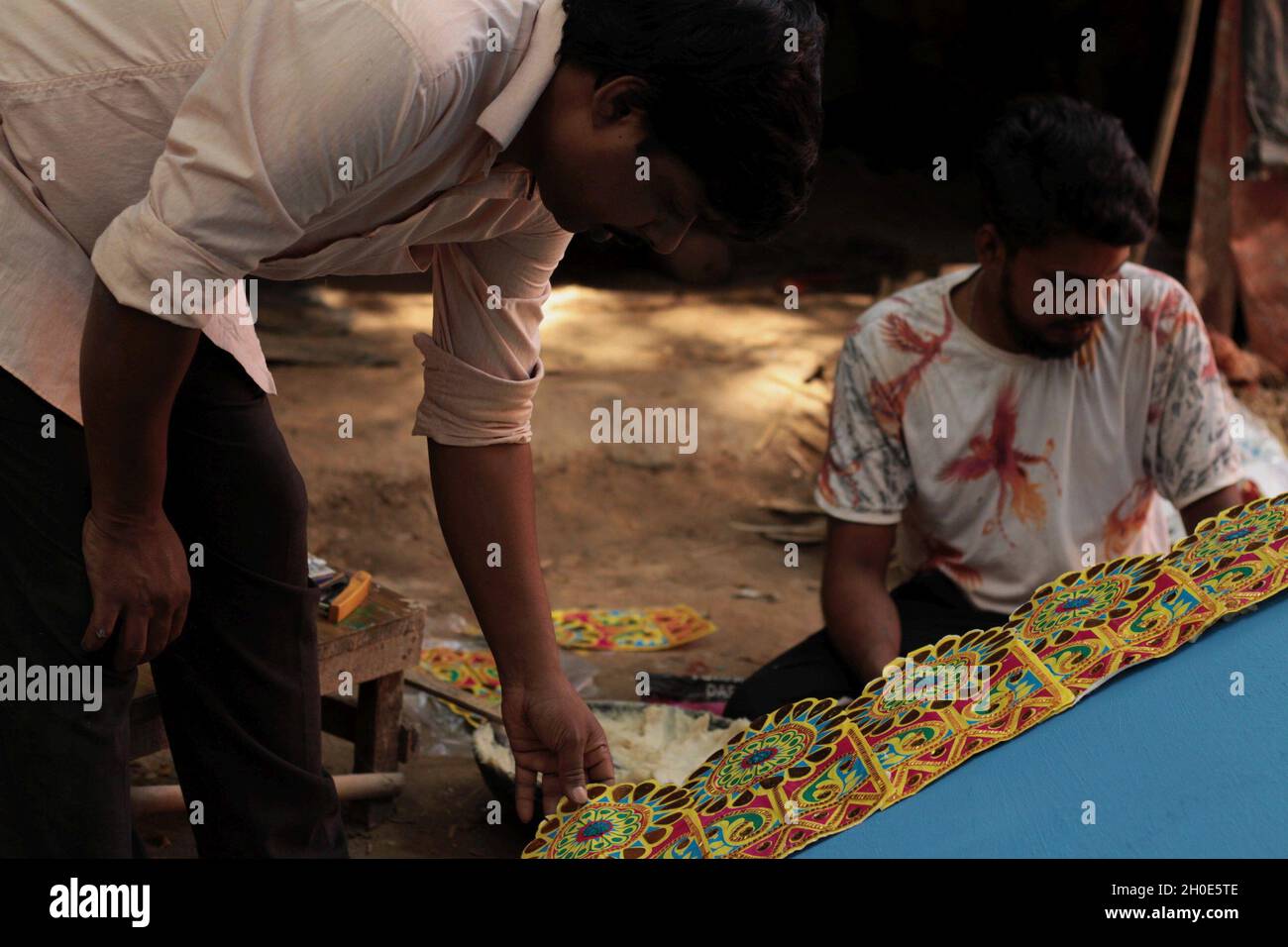 New Delhi, India. 11th Oct, 2021. Artist Govind Nath (extreme left) working with his artisans ...