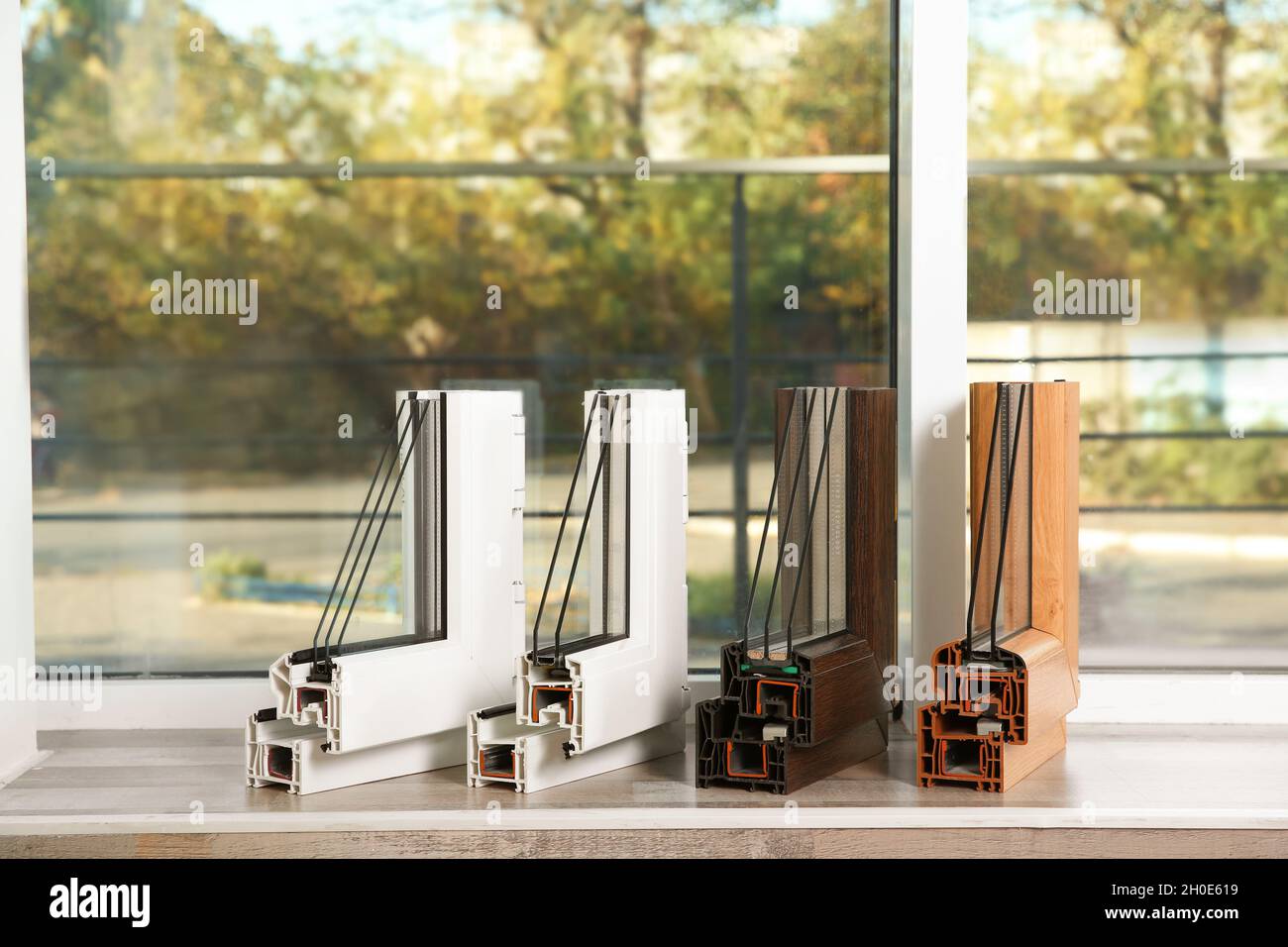Samples of modern window profiles on sill indoors. Installation service ...