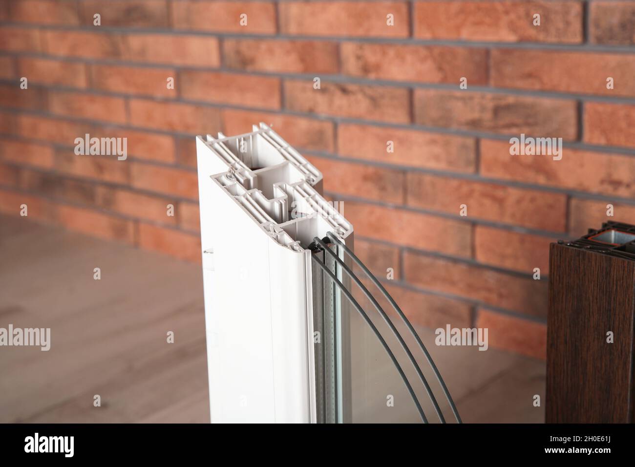 Sample of modern window profile near brick wall. Installation service ...