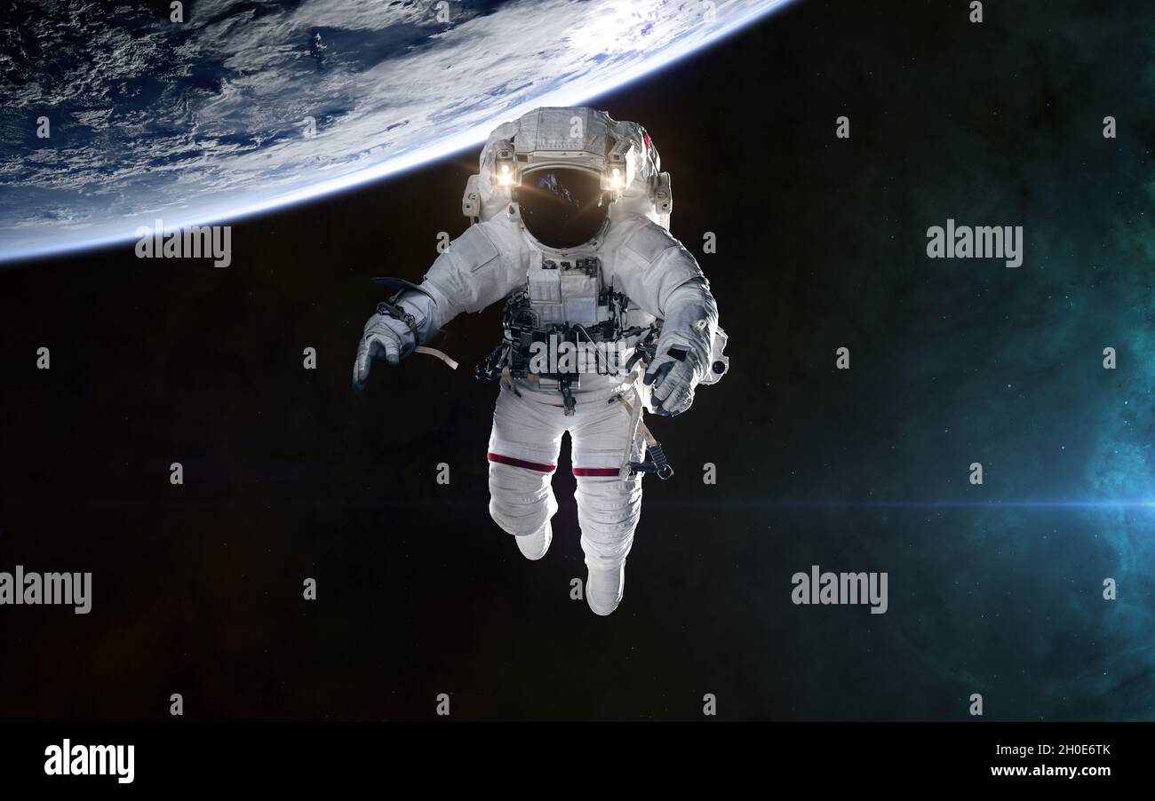 Astronaut orbiting planet Earth. Solar system Stock Photo - Alamy