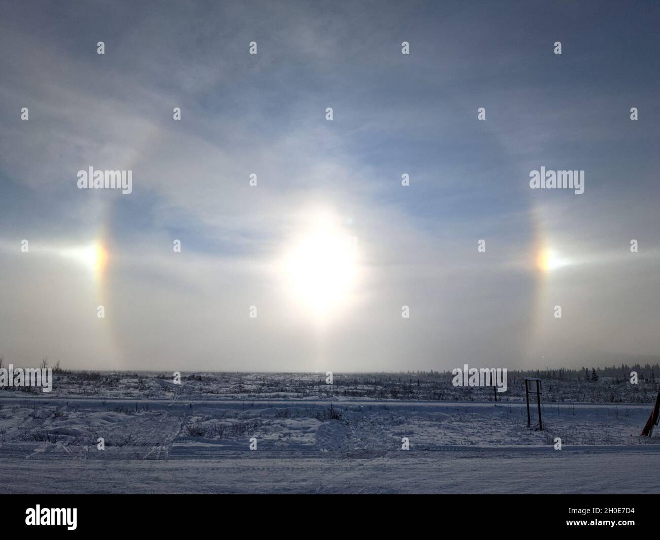 A sun halo, formed by the refraction and reflection of light off tiny ...