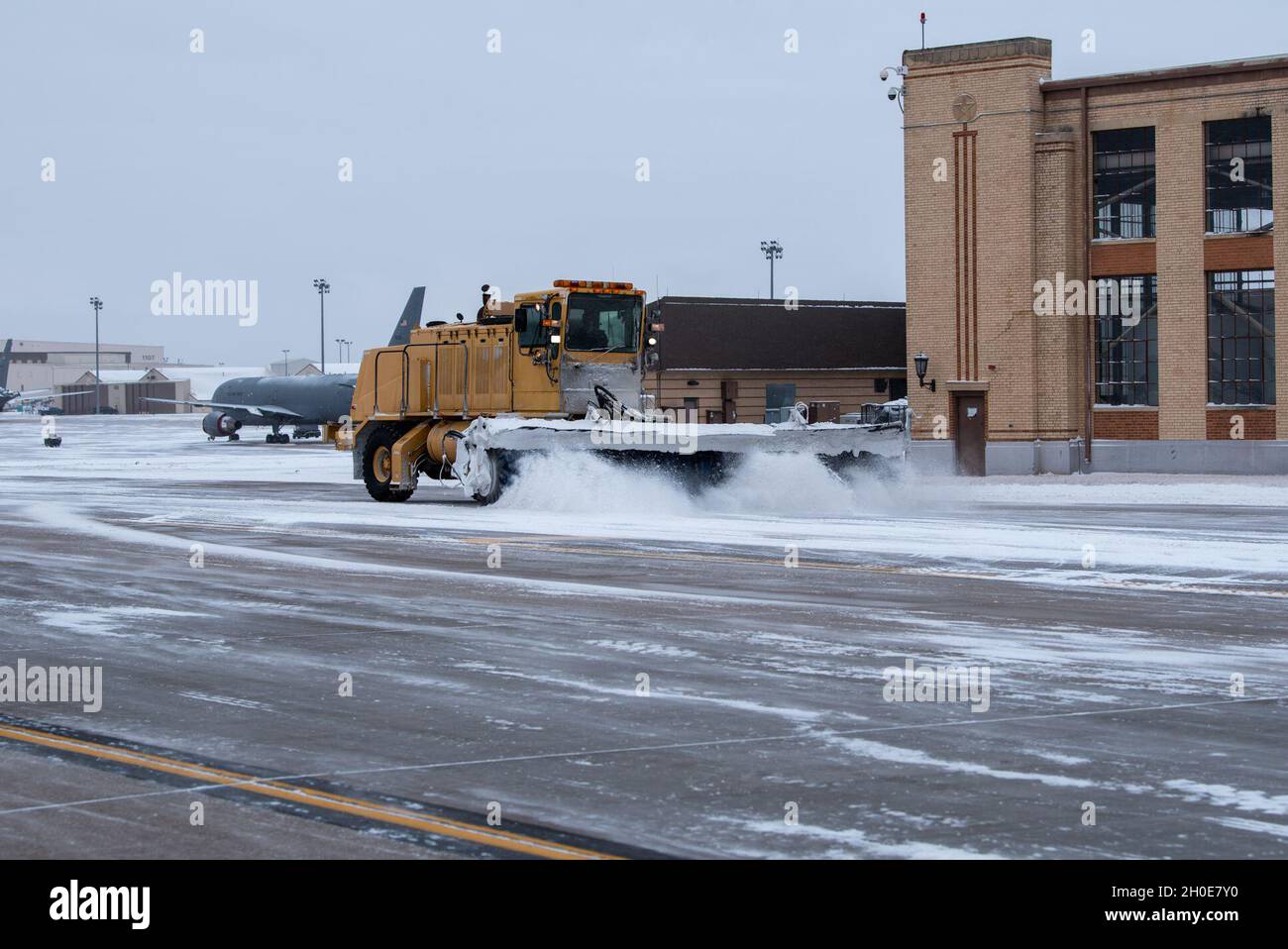 Heavy equipment vehicle operator Airmen use an Oshkosh Snow Broom, a ...