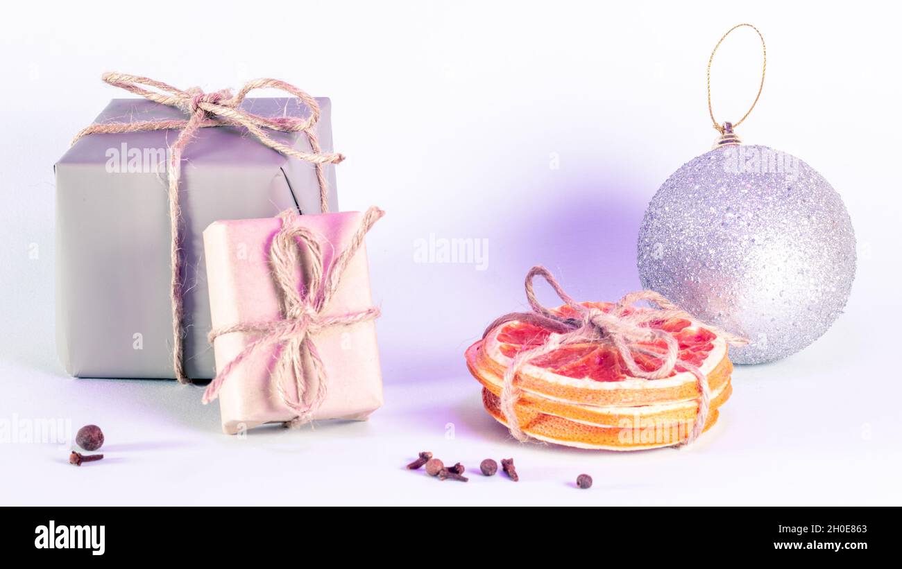 Christmas gifts in craft style with pile slices of dry grapefruit and ...