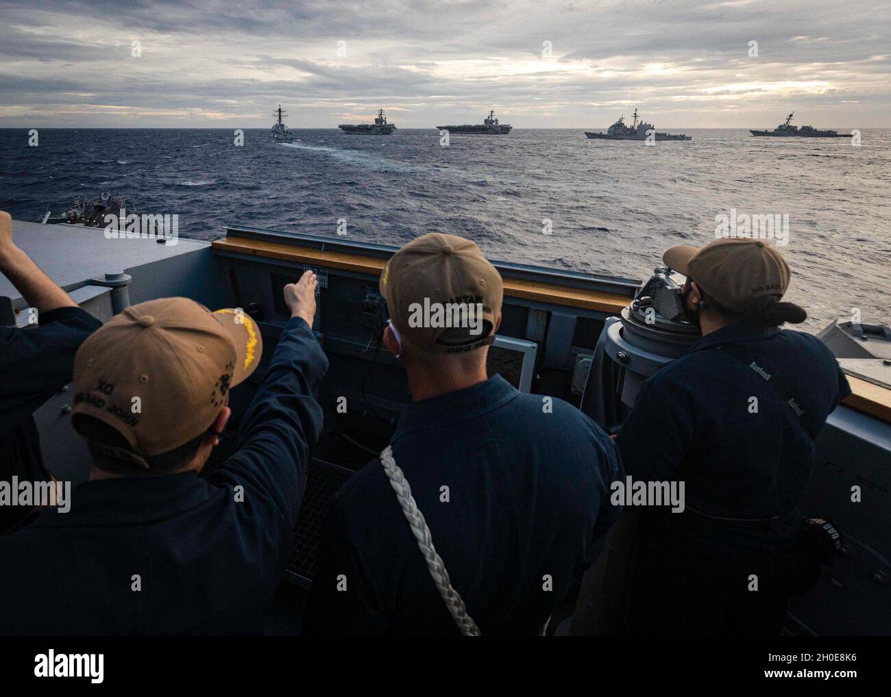 Cmdr. Ryan T. Easterday, center, commanding officer of the Arleigh ...