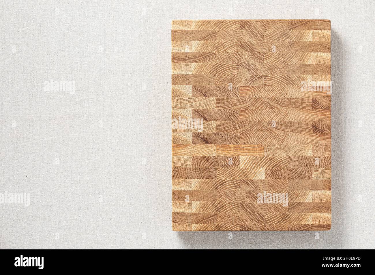 Oak spliced wooden cutting board on burlap. The cross-section of the ...