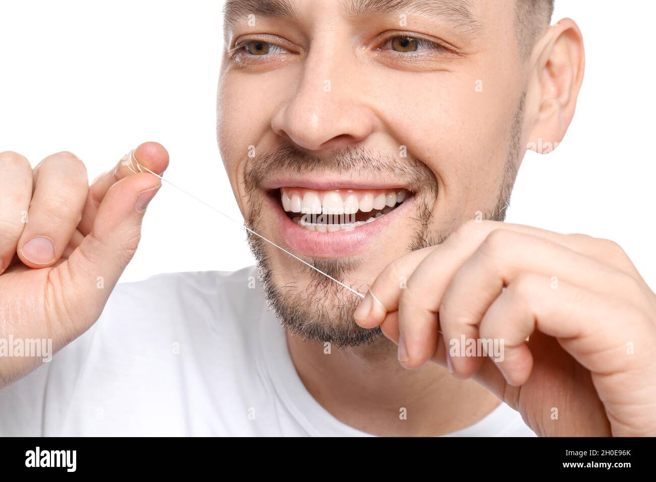 Young man flossing his teeth on white background Stock Photo - Alamy