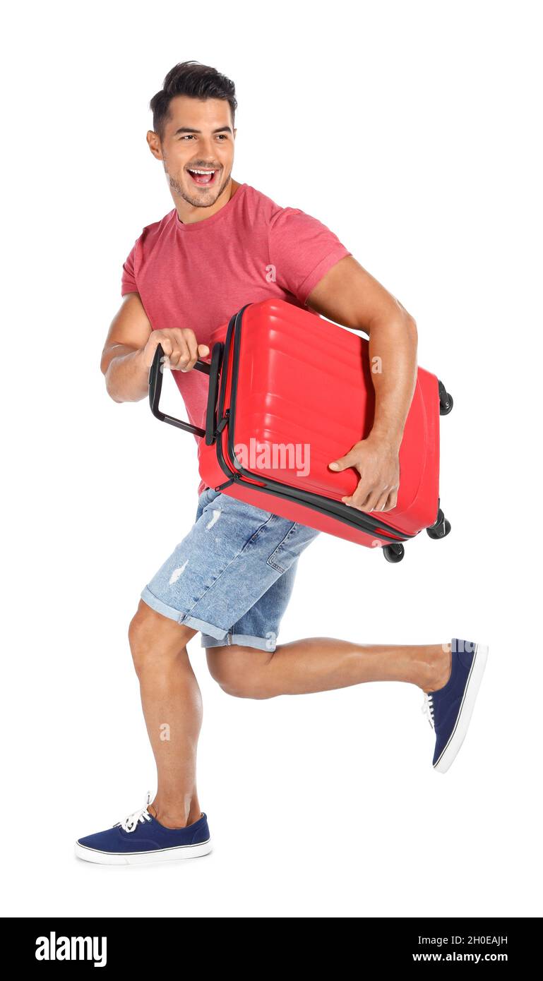 Young man running with suitcase on white background Stock Photo - Alamy