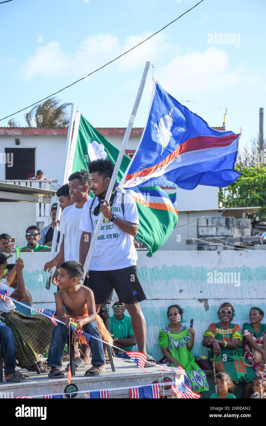 Ebeye youths bearing the flags of Kwajalein Atoll and the Republic of ...