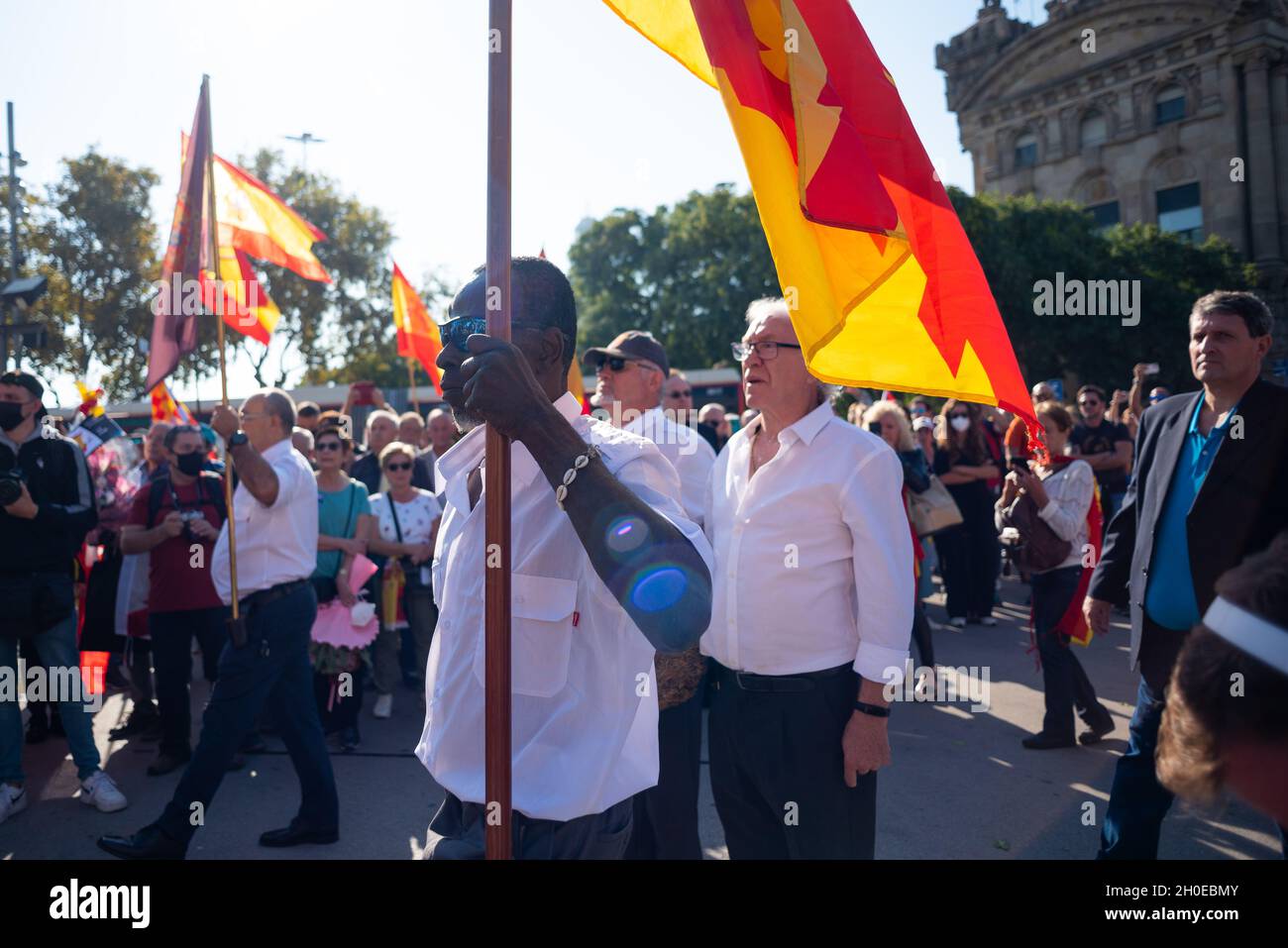 A person of color hold the spanish flag during demonstrations for the ...