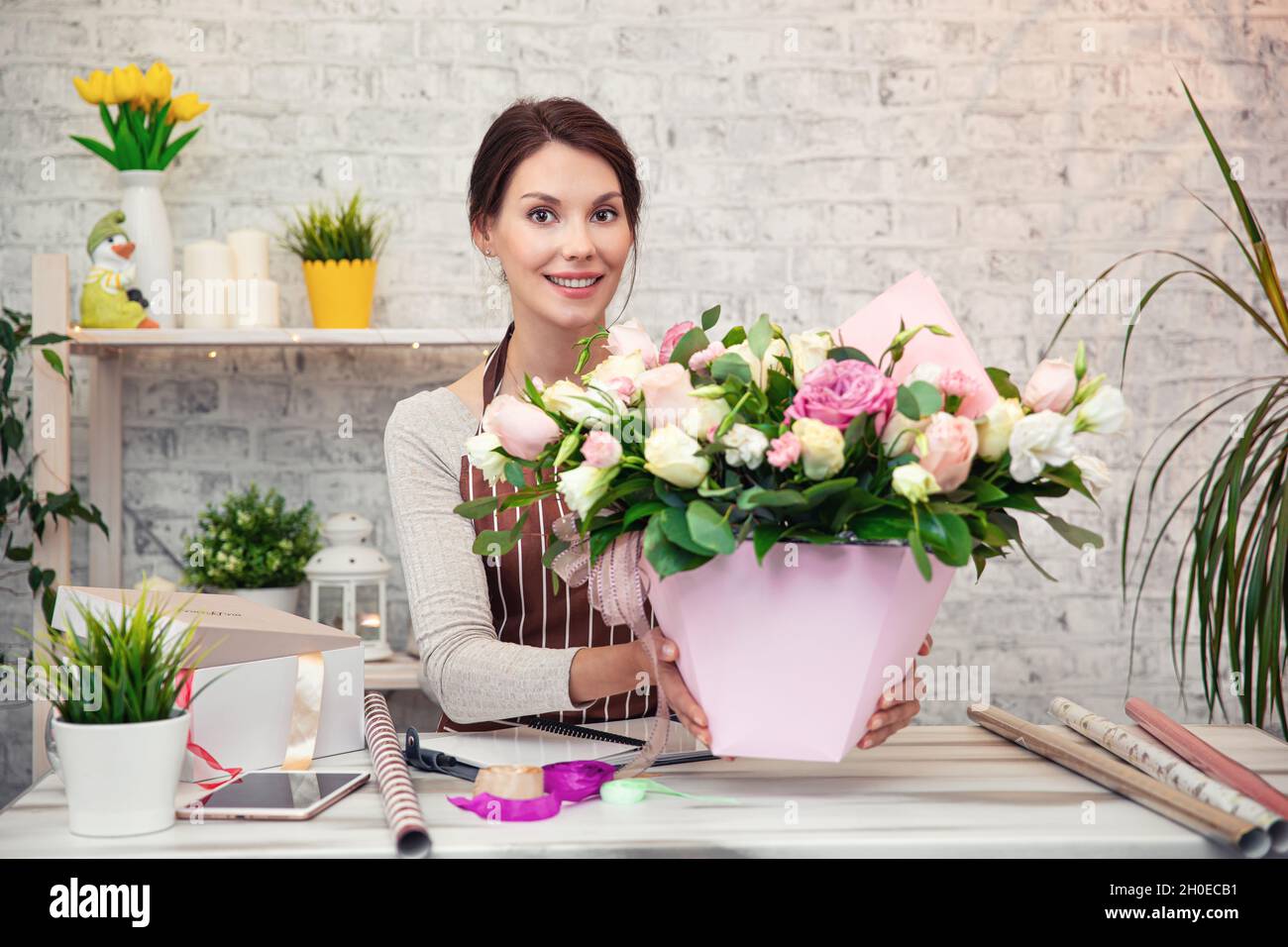 Young woman florist at work. Business woman sale and floristry concept ...
