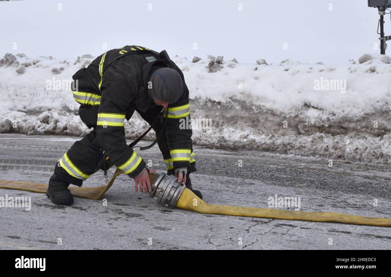 A Rock Island firefighter connects a hose in order to quickly gain ...