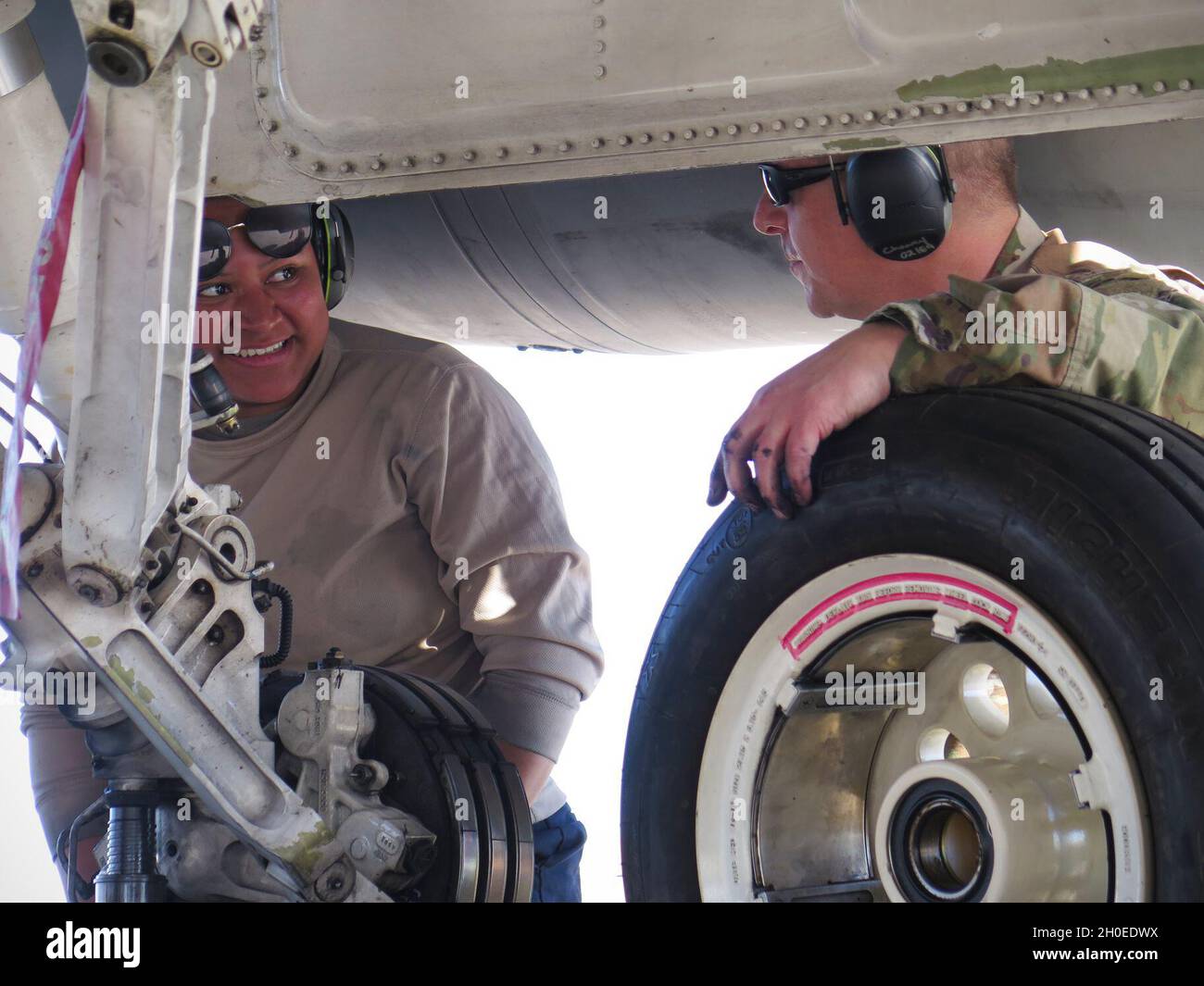 U.S. Air Force Chief Master Sgt. Erin Chaney assists crew chief, Airman ...