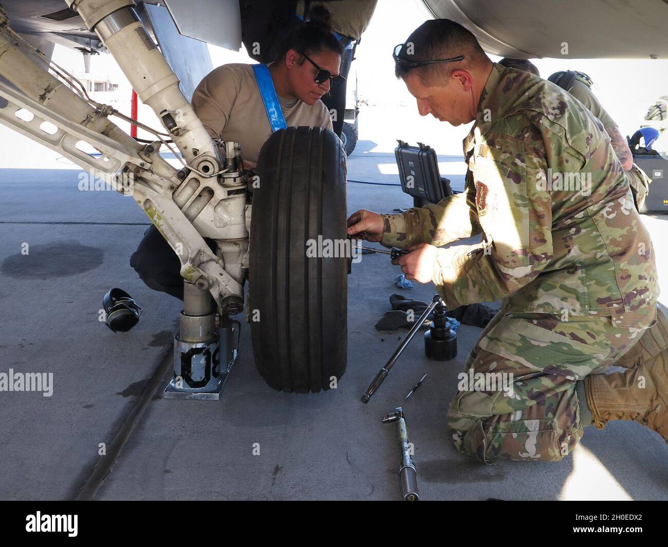 U.S. Air Force Chief Master Sgt. Erin Chaney assists crew chief, Airman ...