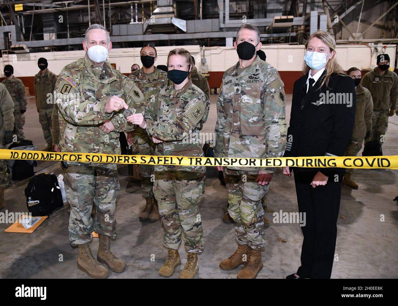 Maj. Gen. Dennis LeMaster, MEDCoE Commanding General, presents a coin ...