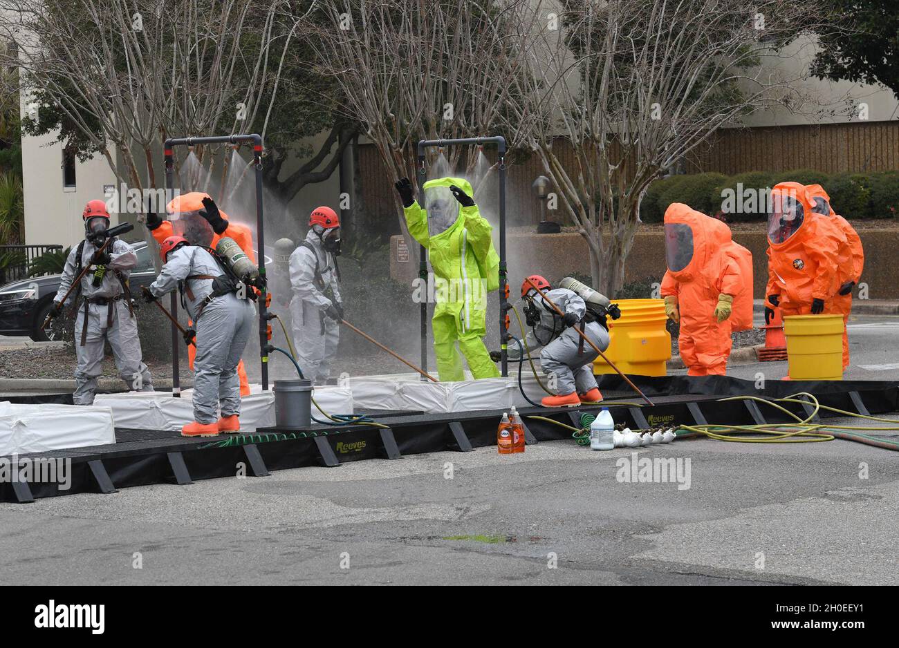 Emergency response team members walk through a decontamination line ...