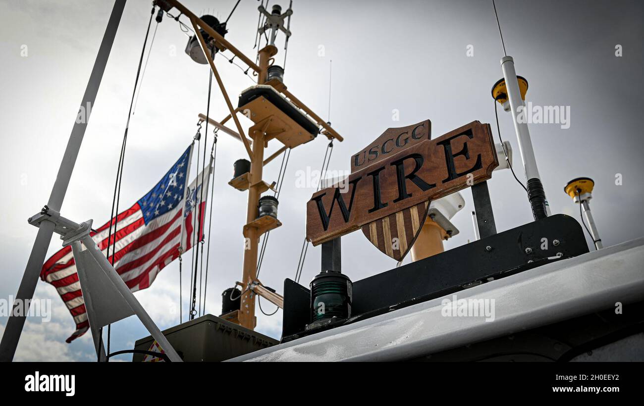 The national ensign blows in the wind as Coast Guard Cutter Wire breaks ...