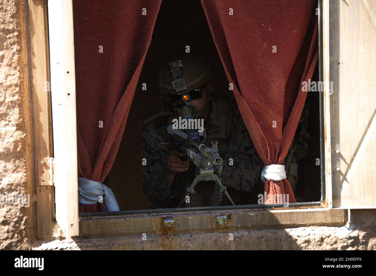 A U.S. Marine with Charlie Company, 1st Battalion, 3d Marines, aims his ...