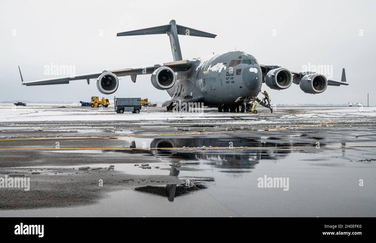 A snow-covered C-17 Globemaster III, assigned to the 62nd Airlift Wing ...