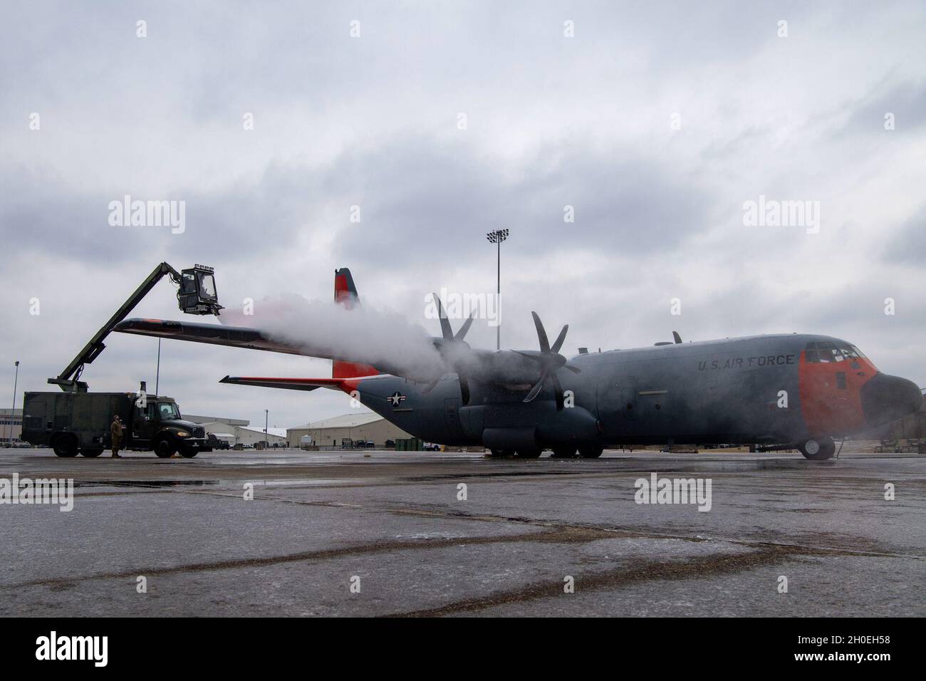 An Airman from the 19th Aircraft Maintenance Squadron de-ices a C-130J ...