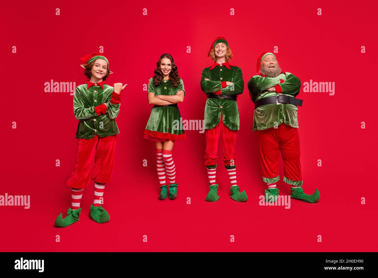 Full size photo of happy cheerful santa helper hands crossed wear hat ...