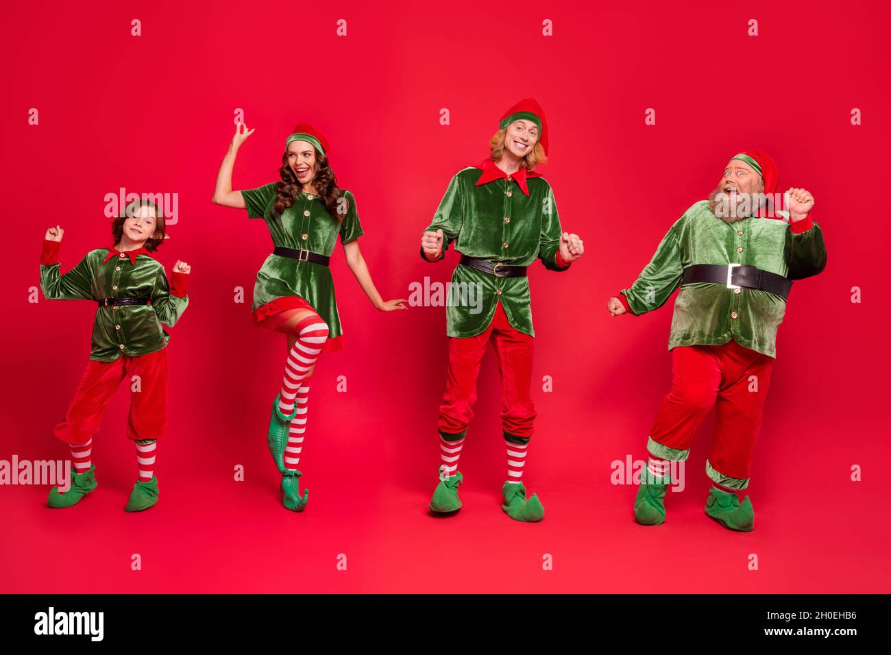 Full length photo of happy, elf people dance celebrate xmas wear hat ...