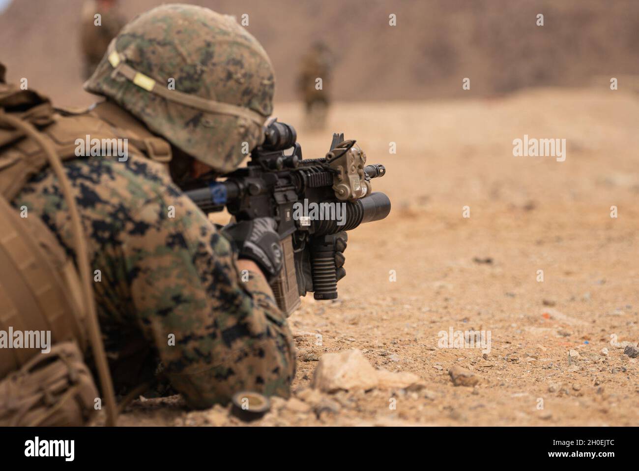 A U.S. Marine with 2nd Battalion, 23rd Marines engages marathon targets ...