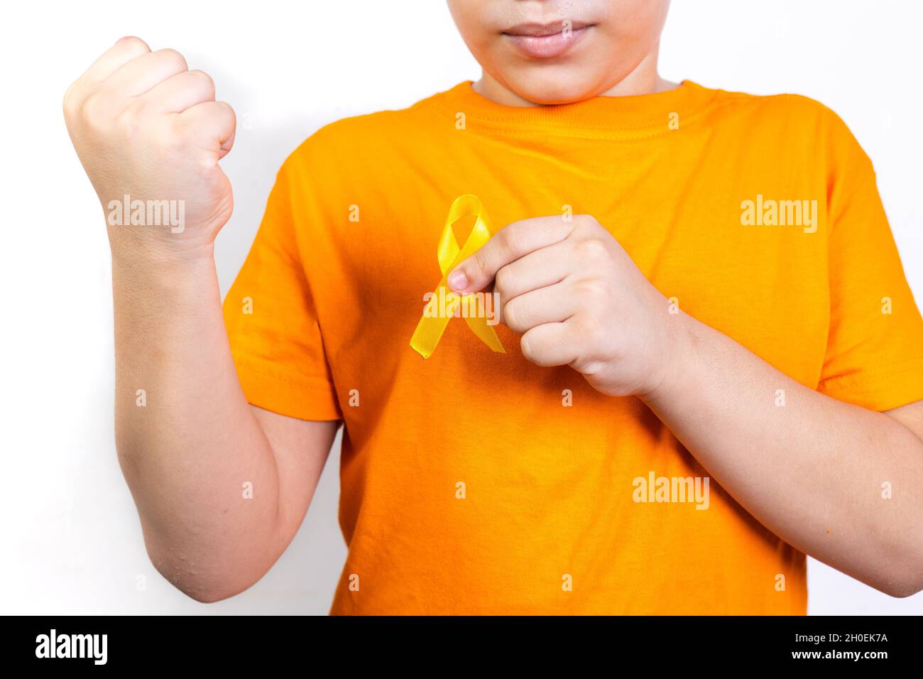 Boy holding childhood cancer awareness ribbon in his left hand and ...