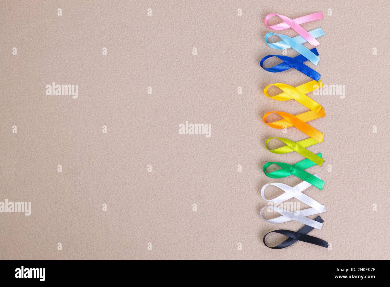 Colorful cancer ribbons isolated on a cream background Stock Photo - Alamy