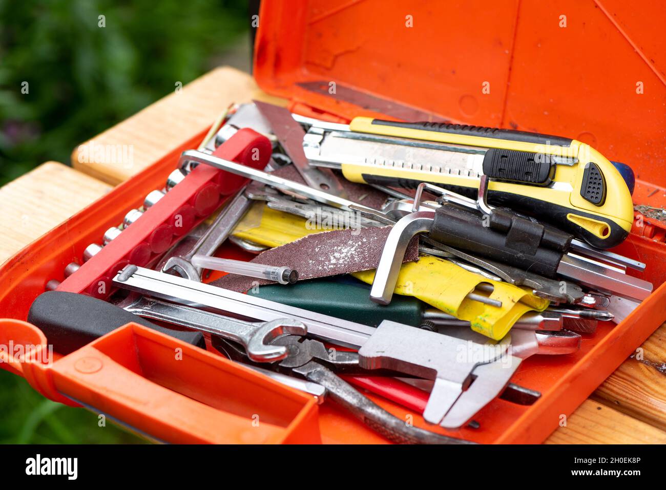 Orange plastic toolkit with instruments lies on wooden bench Stock ...