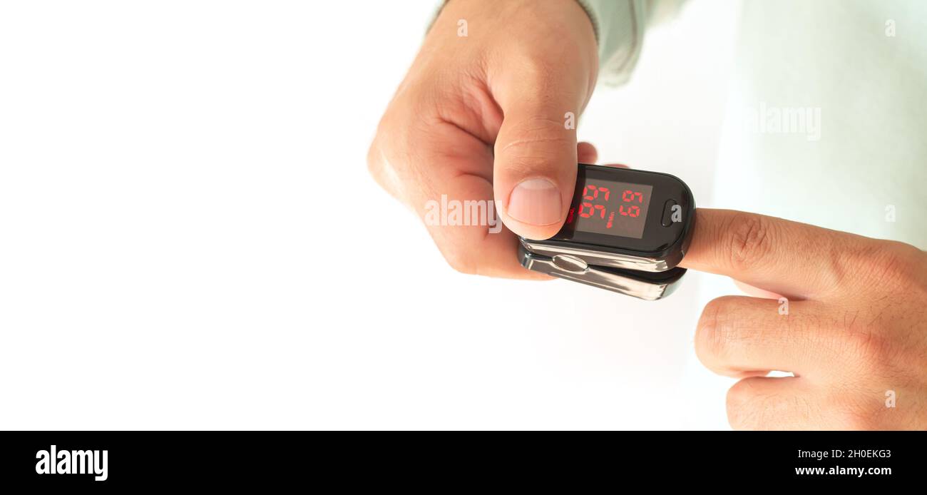 Man checking blood oxygen level with pulse oximeter at home. Health ...